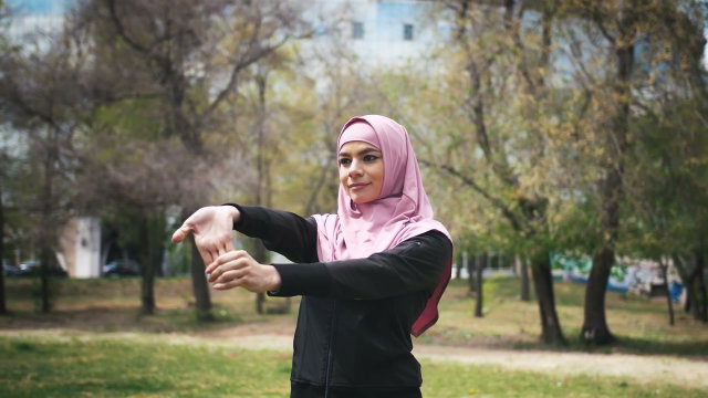 Woman in Hijab Using Phone on Park Bench • Stock Video on Uppbeat