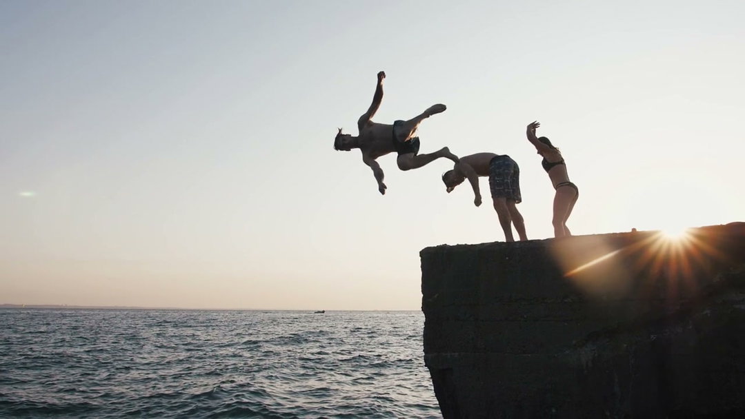 Man Does Front Flip into Sea at Sunset • Stock Video on Uppbeat