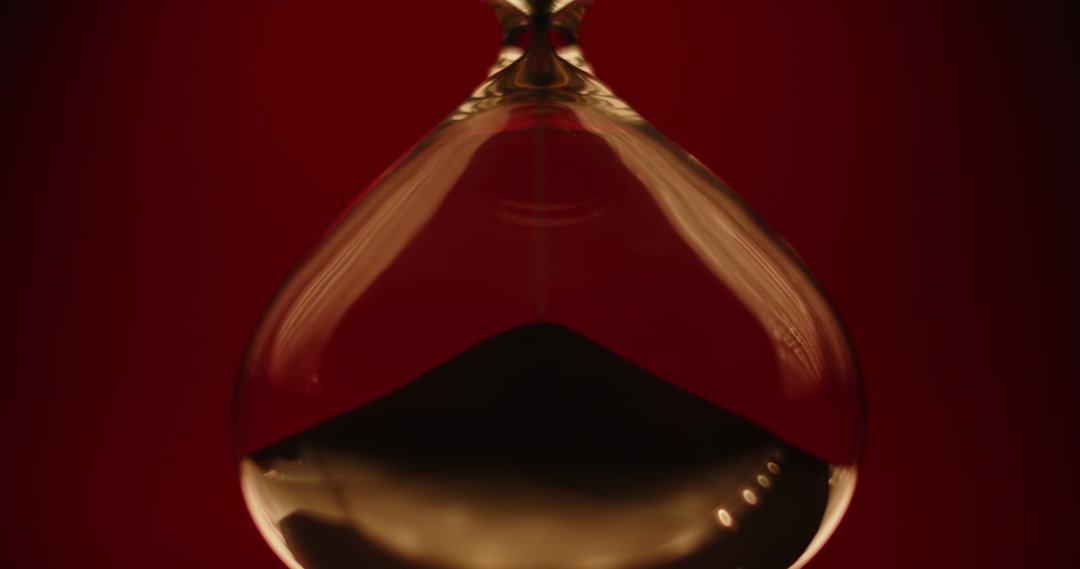 Black Sand Flowing in Hourglass Close-Up • Stock Video on Uppbeat