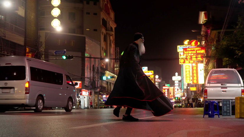 Man in Yellow Robes Walks on Tree-Lined Path • Stock Video on Uppbeat