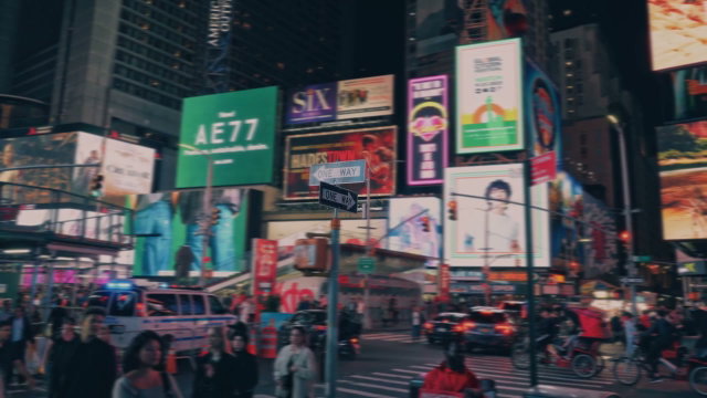 Woman Walks Through Times Square, New York City • Stock Video on Uppbeat