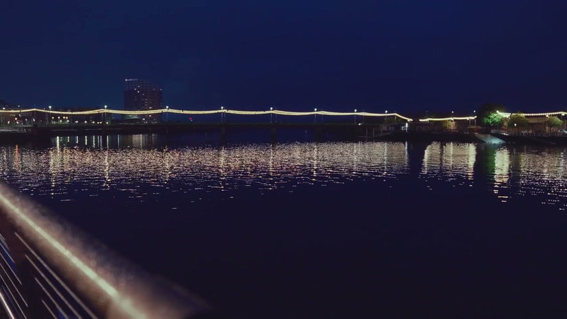 Illuminated City River View at Night • Stock Video on Uppbeat
