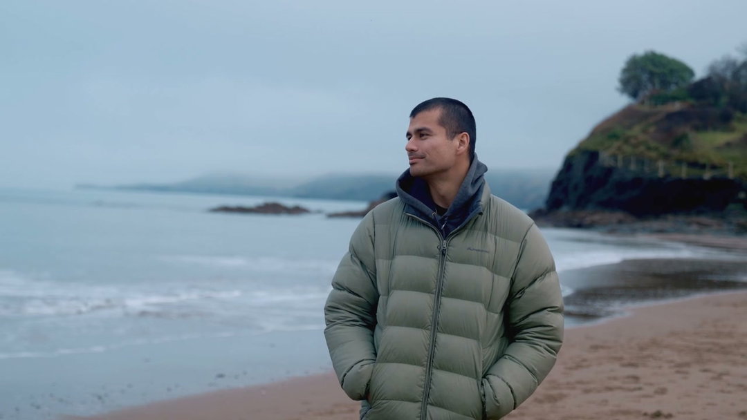 Man Standing on Beach Looking at Ocean • Stock Video on Uppbeat