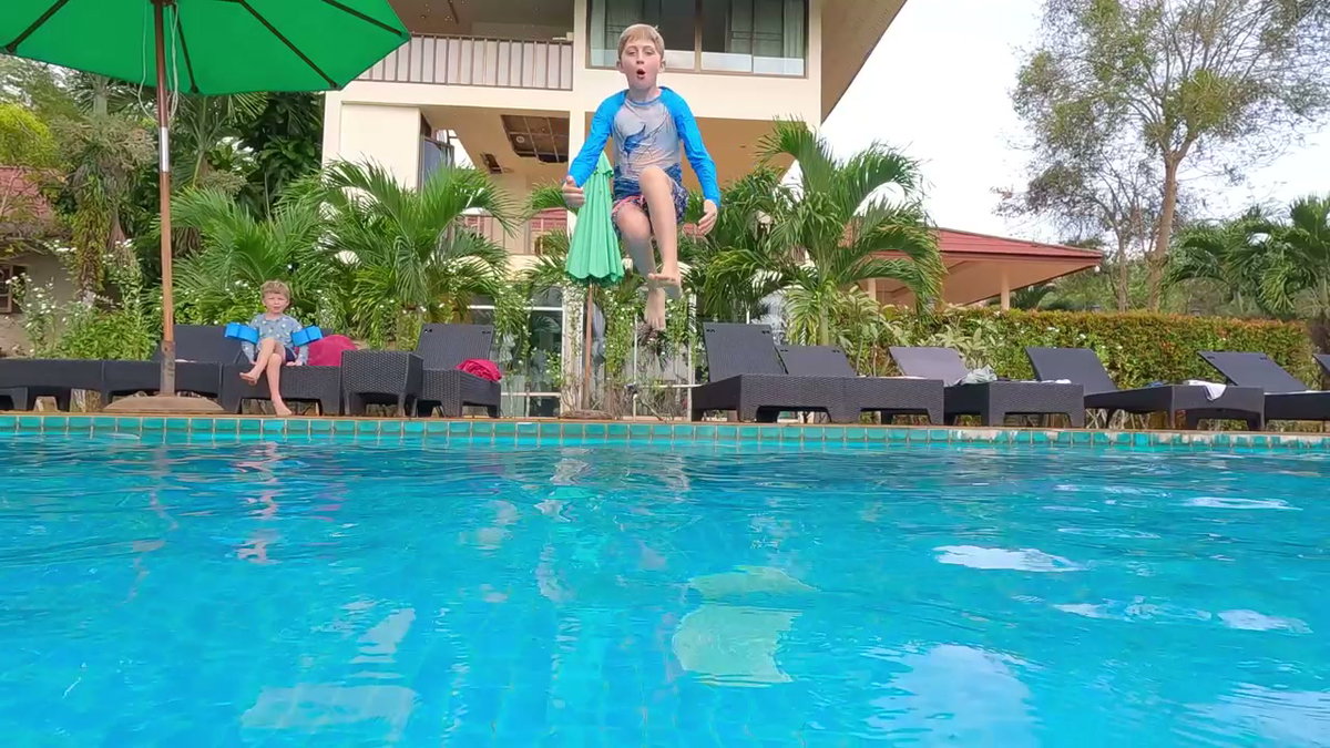 Kids Cannonball Jump into Summer Swimming Pool • Stock Video on Uppbeat