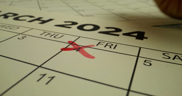 Hand Marking Date on Calendar on Office Desk • Stock Video on Uppbeat