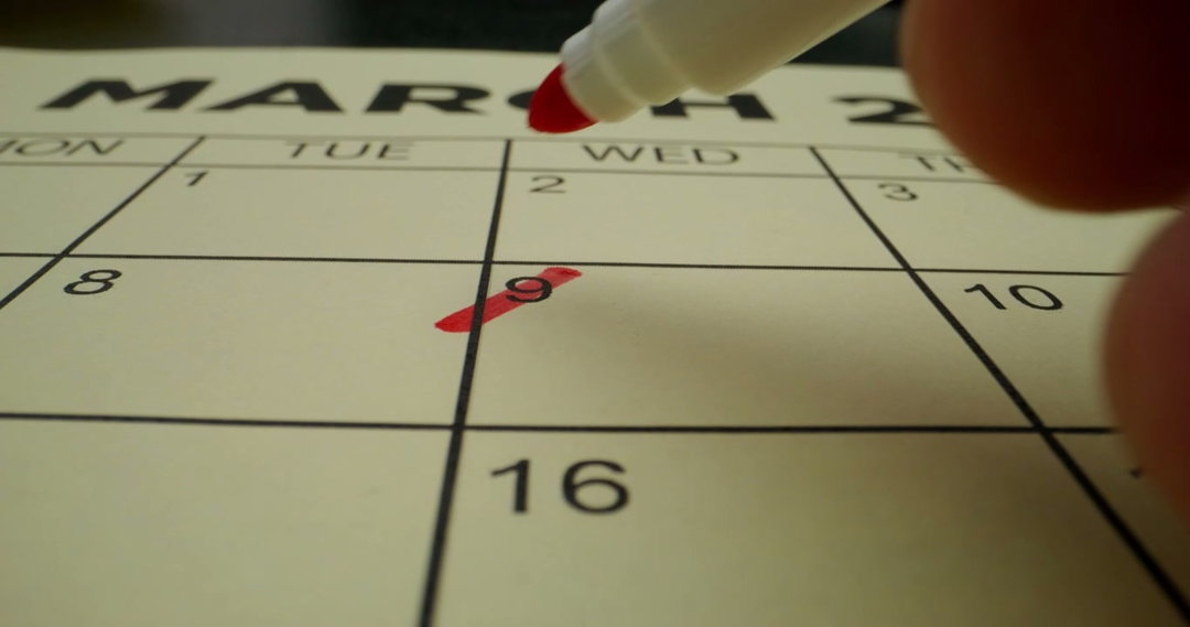 Hand Marking Date on Calendar on Office Desk • Stock Video on Uppbeat