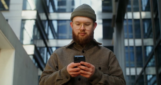 Bearded Man Using Smartphone • Stock Video on Uppbeat